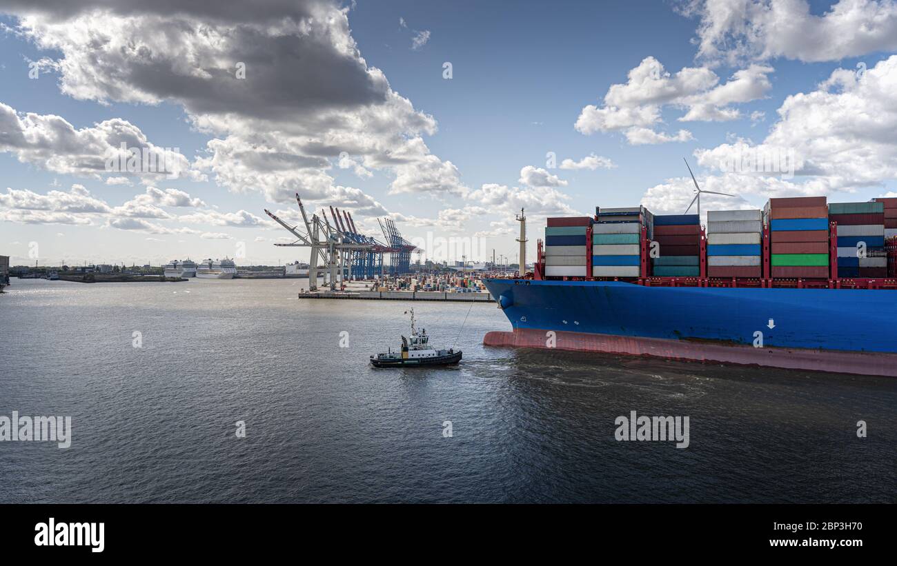 Large container ship arrives in port at a container terminal in good ...