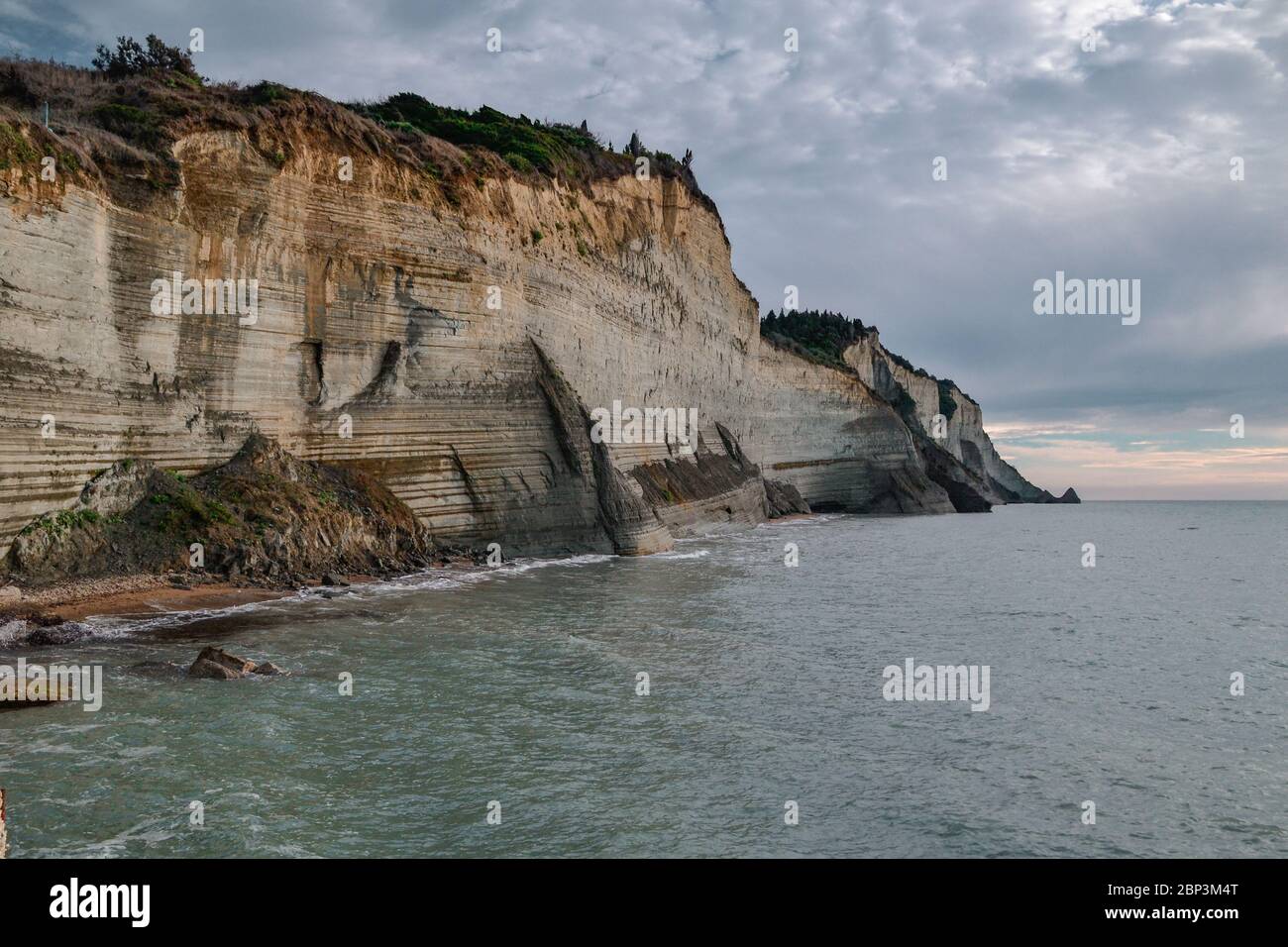 Logas Beach with azure water and amazing rocky cliff in Peroulades ...