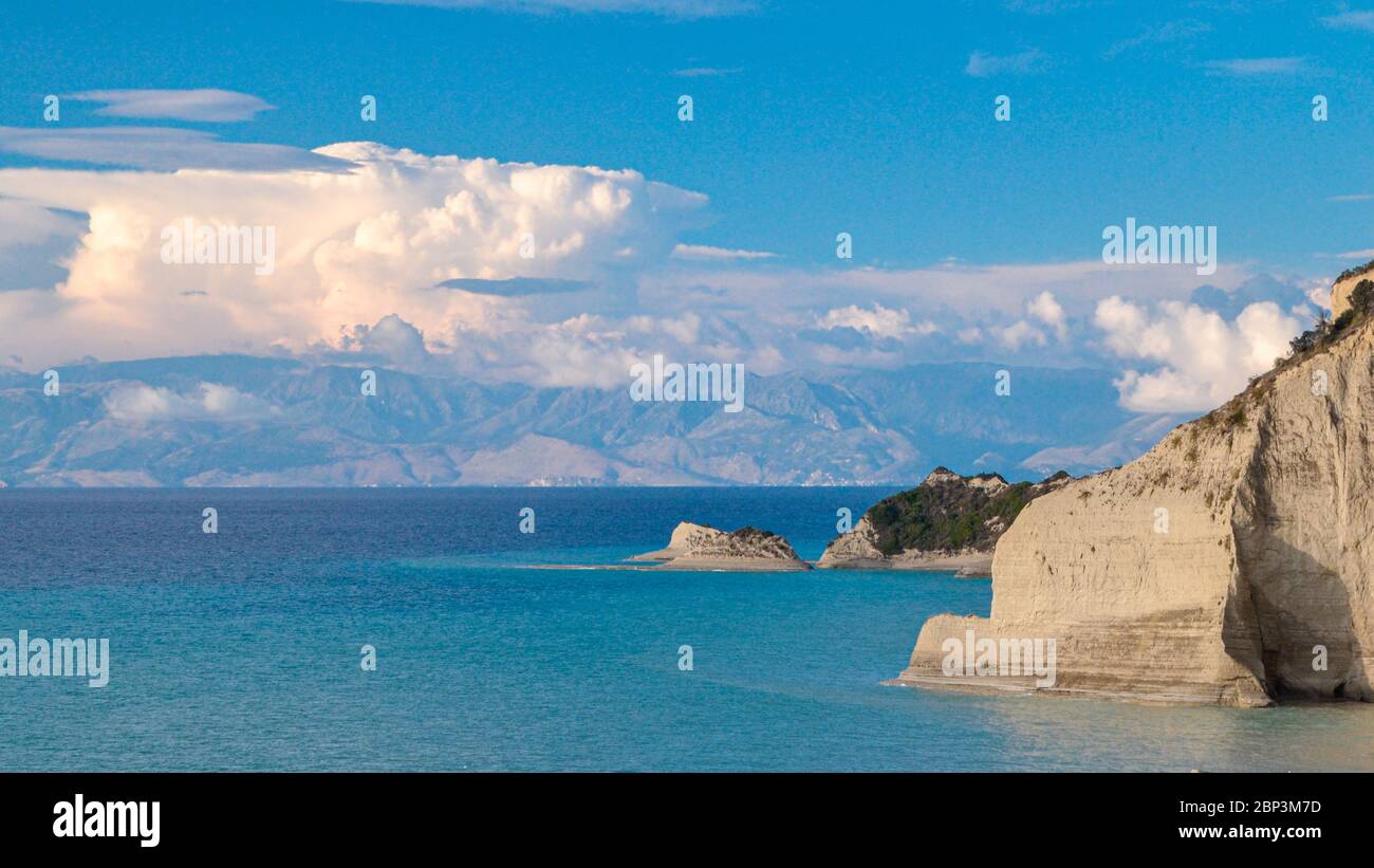 Logas Beach with azure water and amazing rocky cliff in Peroulades ...