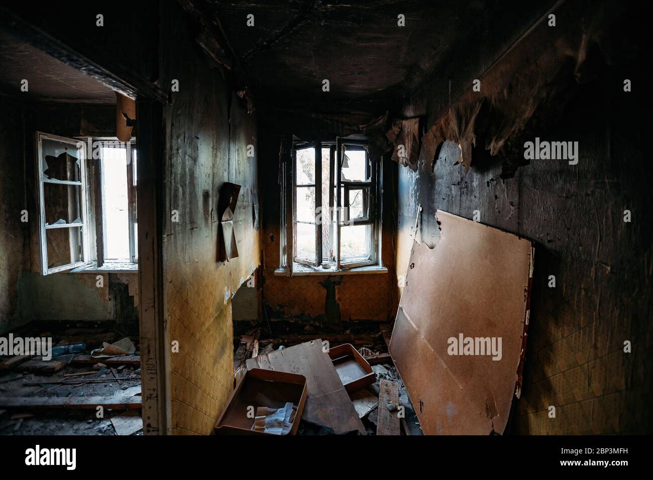 Burnt old house interior. Ruined coridor walls in black soot ...