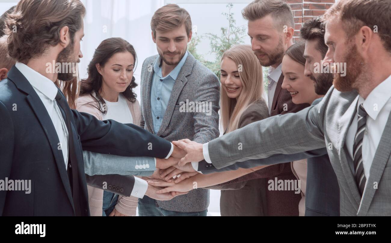 close up. a group of corporate employees showing their unity Stock ...