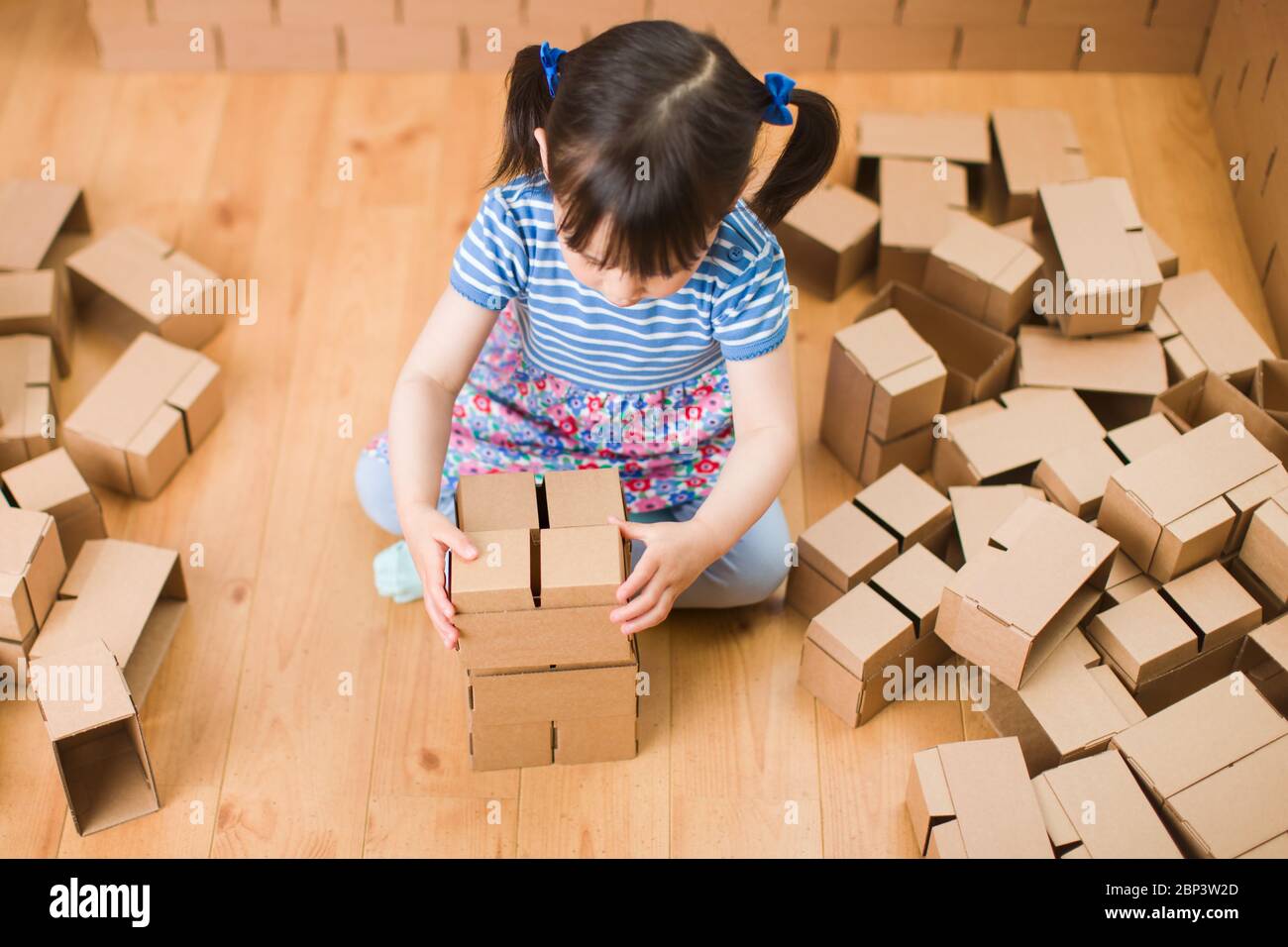toddler girl use carton blocks to build house at home Stock Photo - Alamy