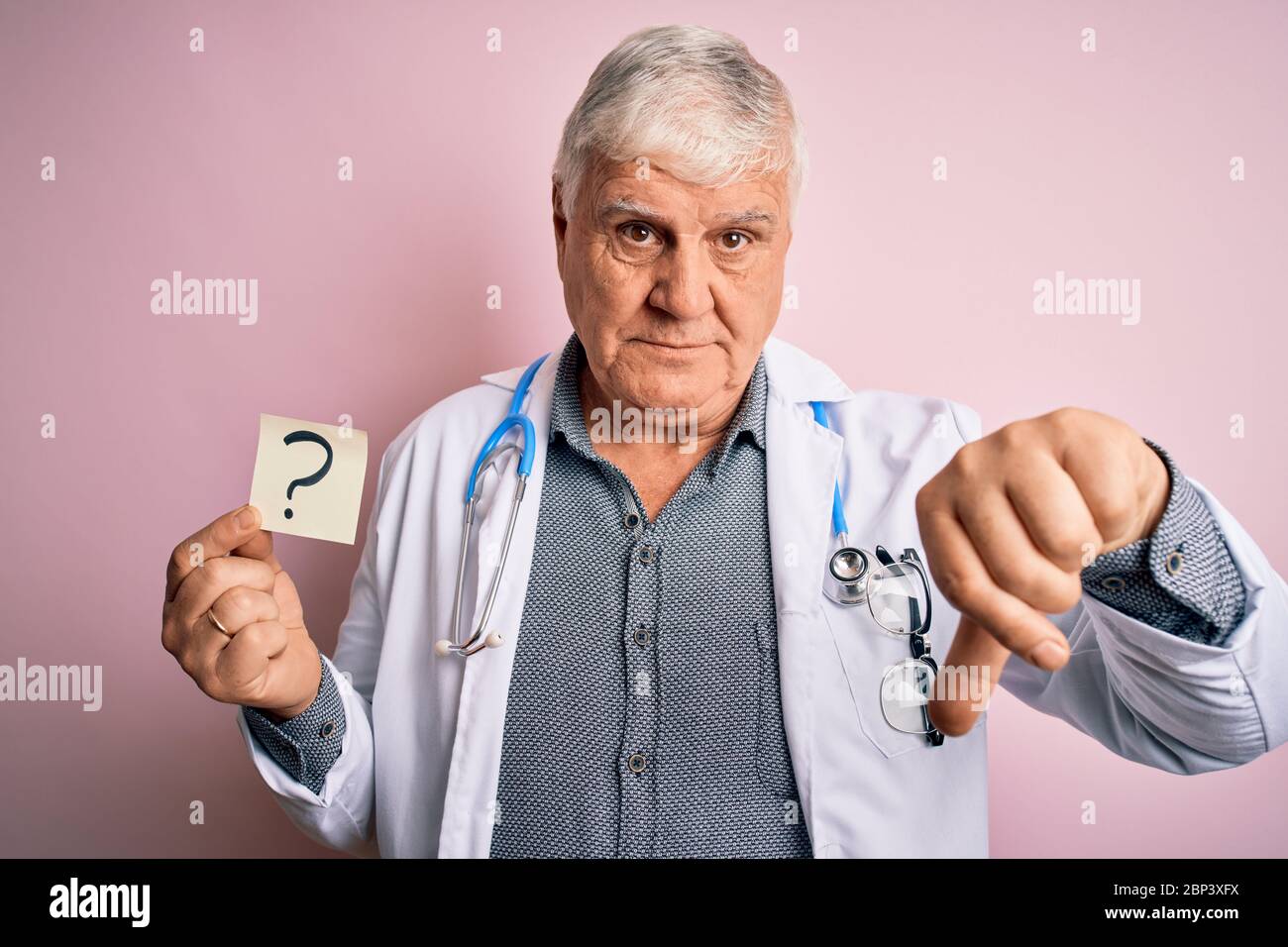 Senior handsome hoary doctor man wearing stethoscope holding reminder ...