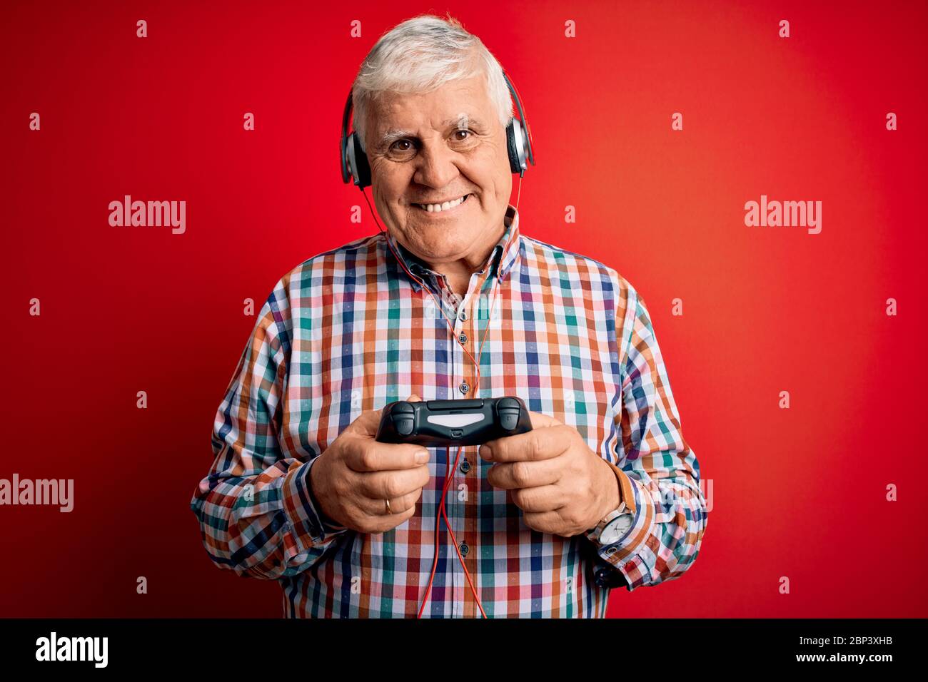 Senior handsome hoary gamer man playing video game using joystick and ...