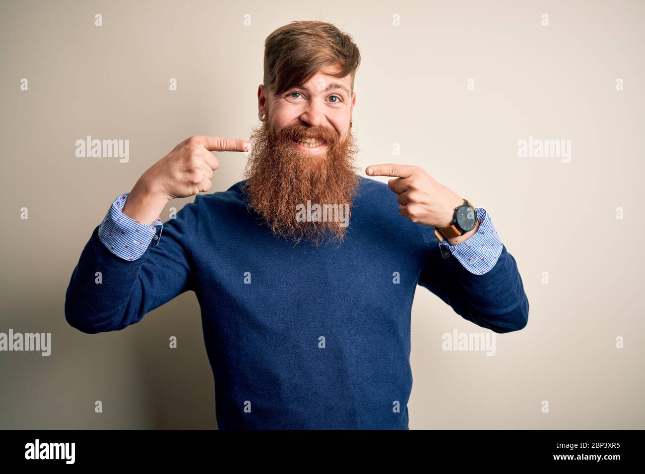 Handsome Irish redhead business man with beard standing over isolated ...