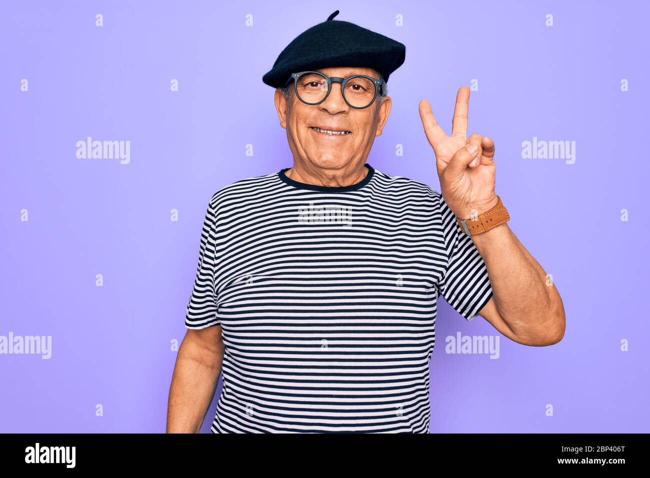 Senior handsome hoary man wearing french beret and glasses standing ...