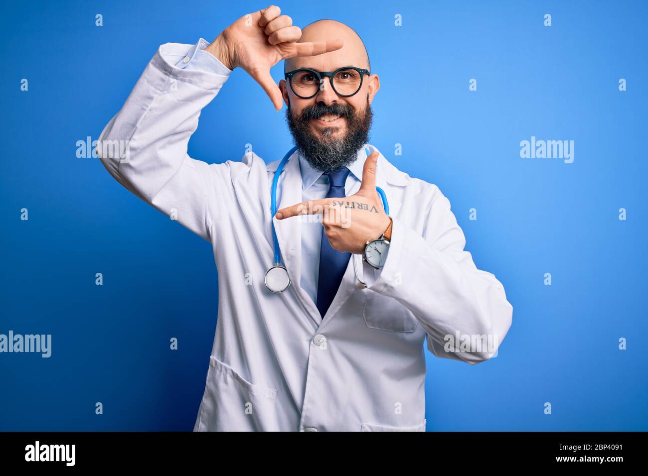 Handsome bald doctor man with beard wearing glasses and stethoscope ...
