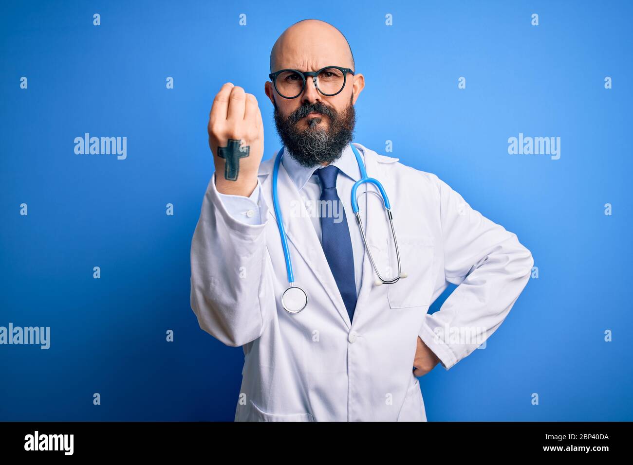 Handsome bald doctor man with beard wearing glasses and stethoscope ...