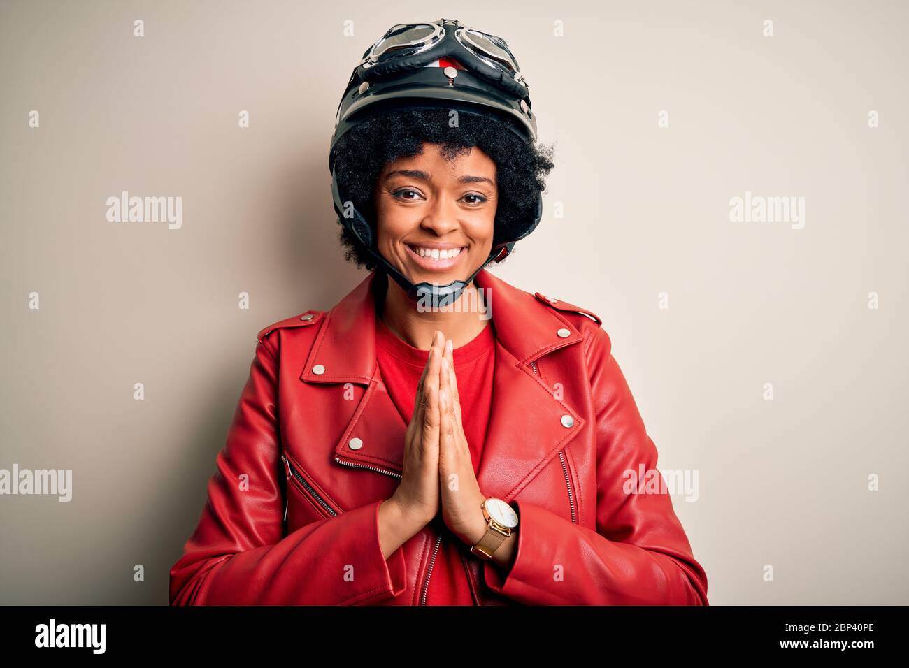 Young African American afro motorcyclist woman with curly hair wearing ...