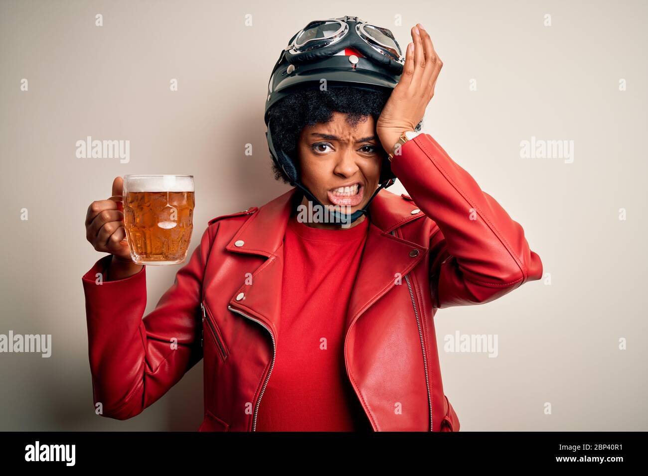 Young African American afro motorcyclist woman with curly hair drinking ...