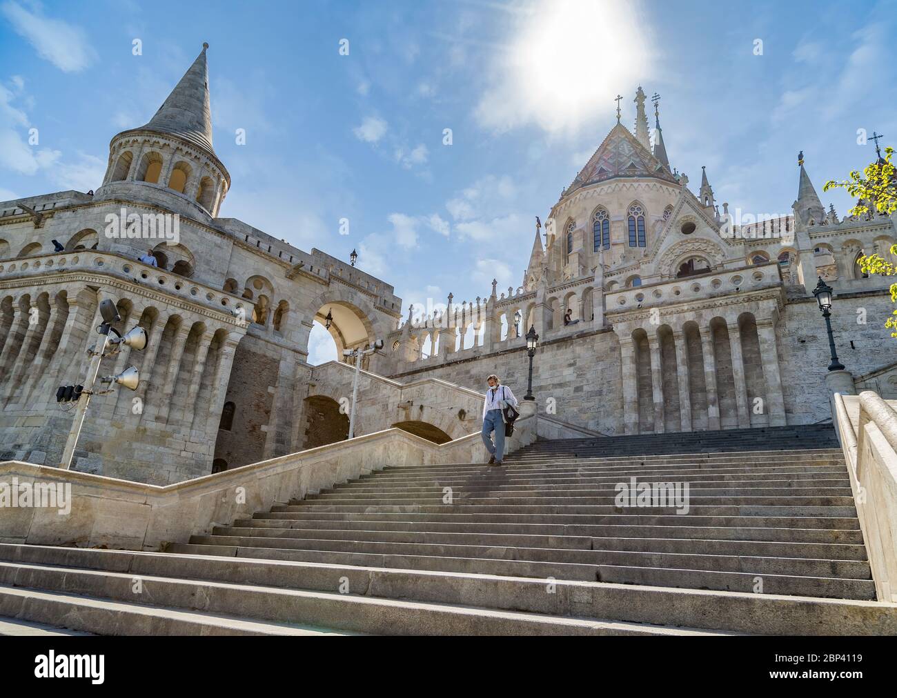 A man walks down the steps of the Fisherman's Bastion, a famous sight ...