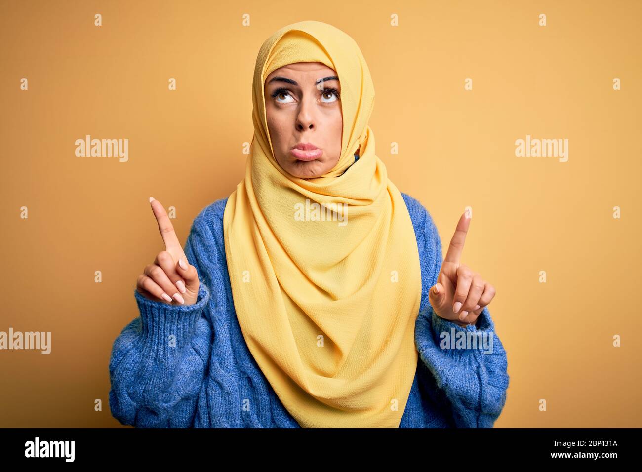 Young beautiful brunette muslim woman wearing arab hijab over isolated ...