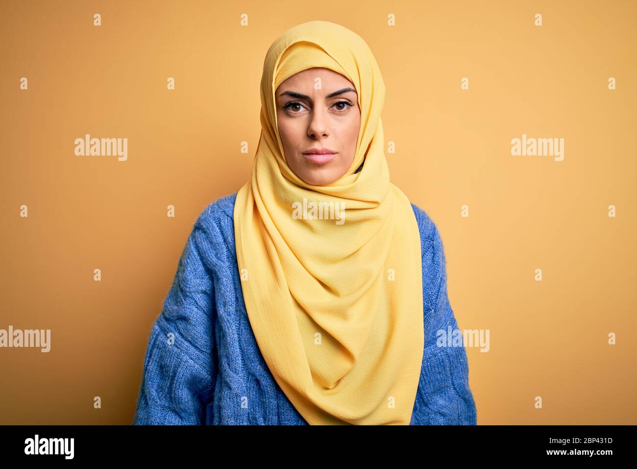 Young beautiful brunette muslim woman wearing arab hijab over isolated ...