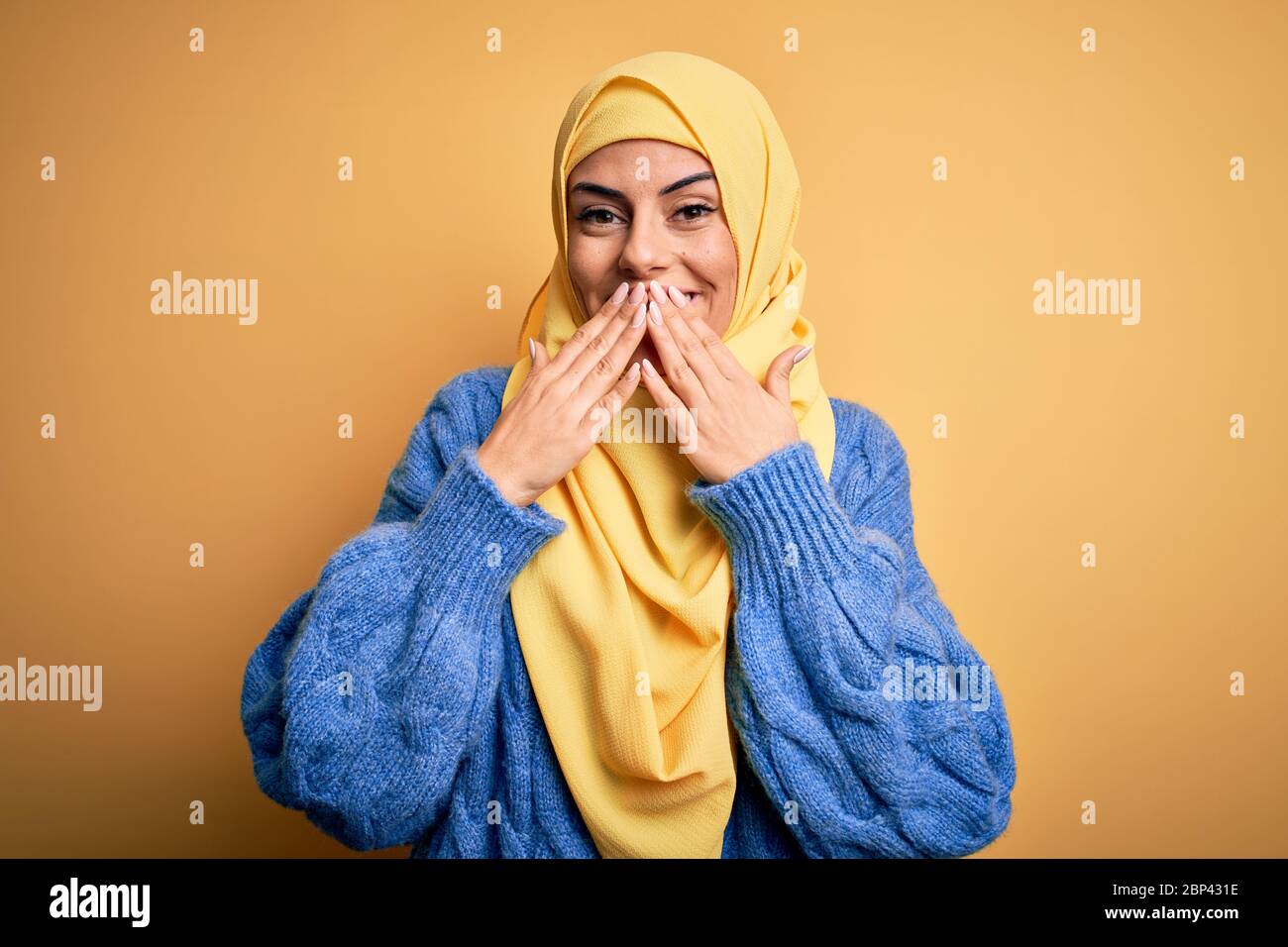 Young beautiful brunette muslim woman wearing arab hijab over isolated ...