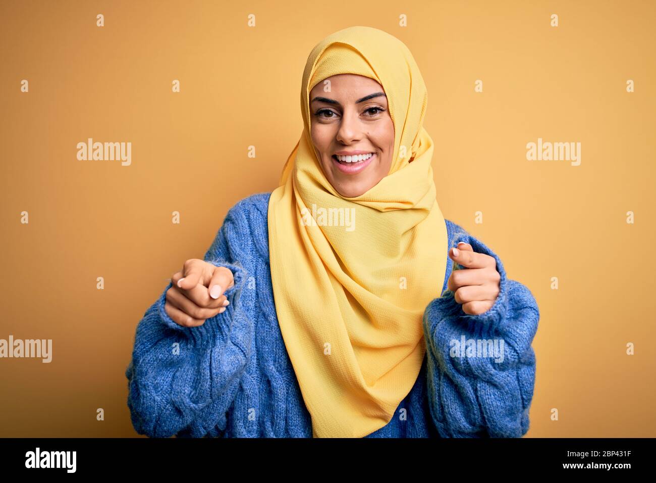 Young beautiful brunette muslim woman wearing arab hijab over isolated ...