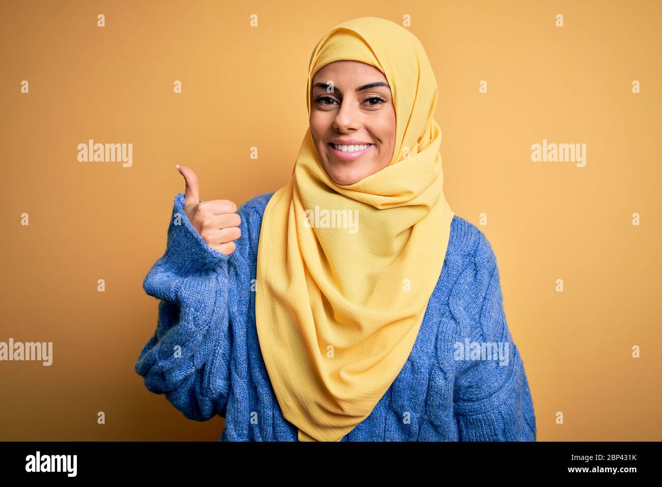 Young beautiful brunette muslim woman wearing arab hijab over isolated ...