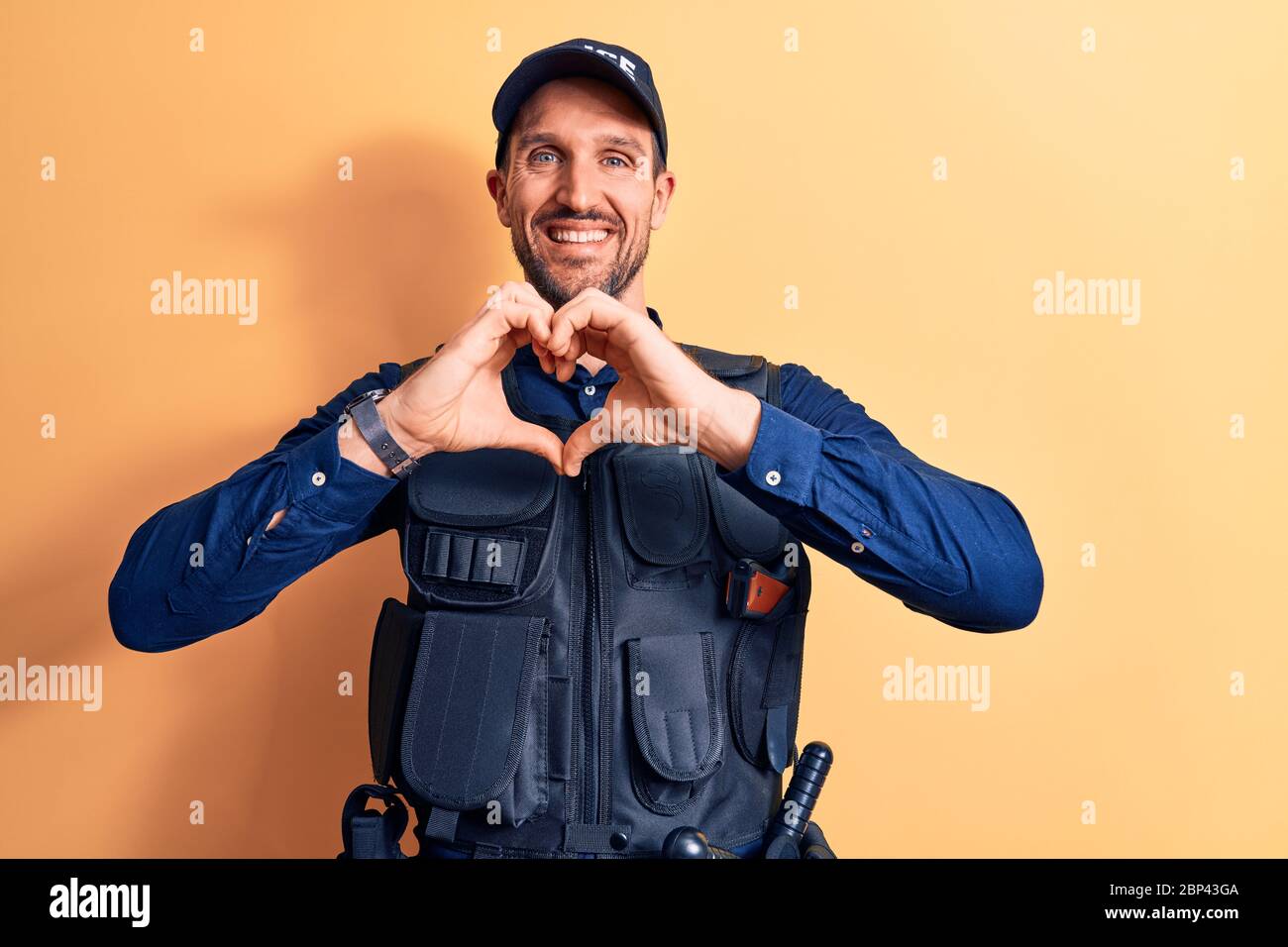 Young handsome policeman wearing police uniform and bulletprof over ...