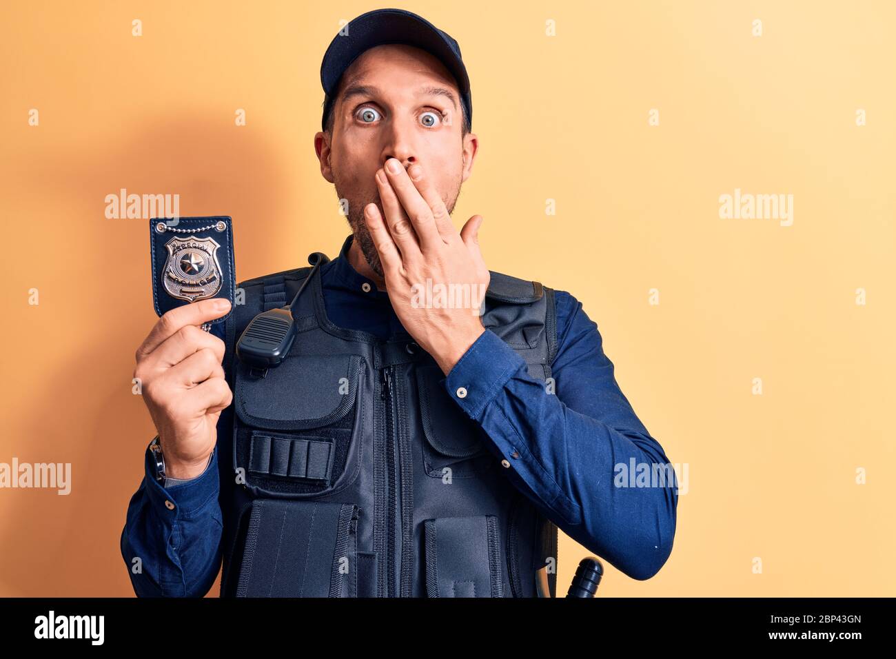 Young handsome policeman wearing uniform and bulletprof holding police ...