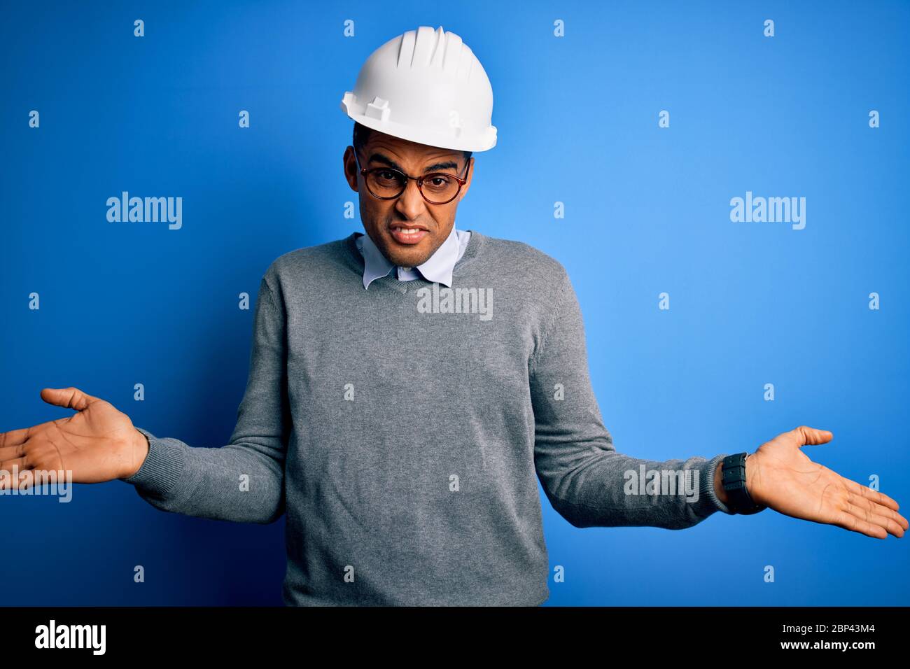 Young handsome african american engineer man with dreadlocks wearing ...
