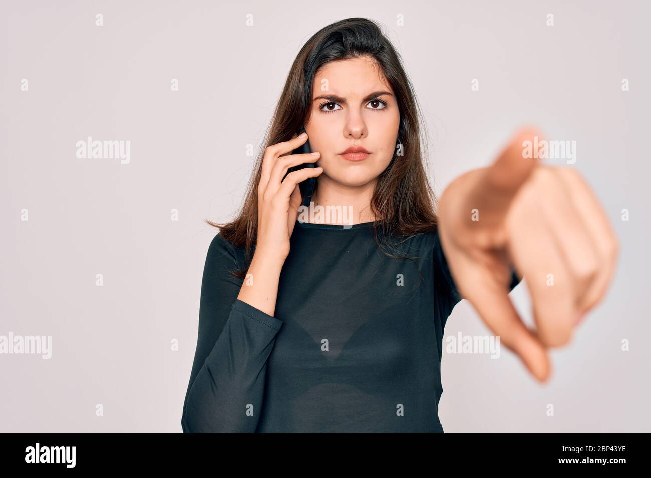 Young beautiful woman having a conversation talking on smartphone ove ...