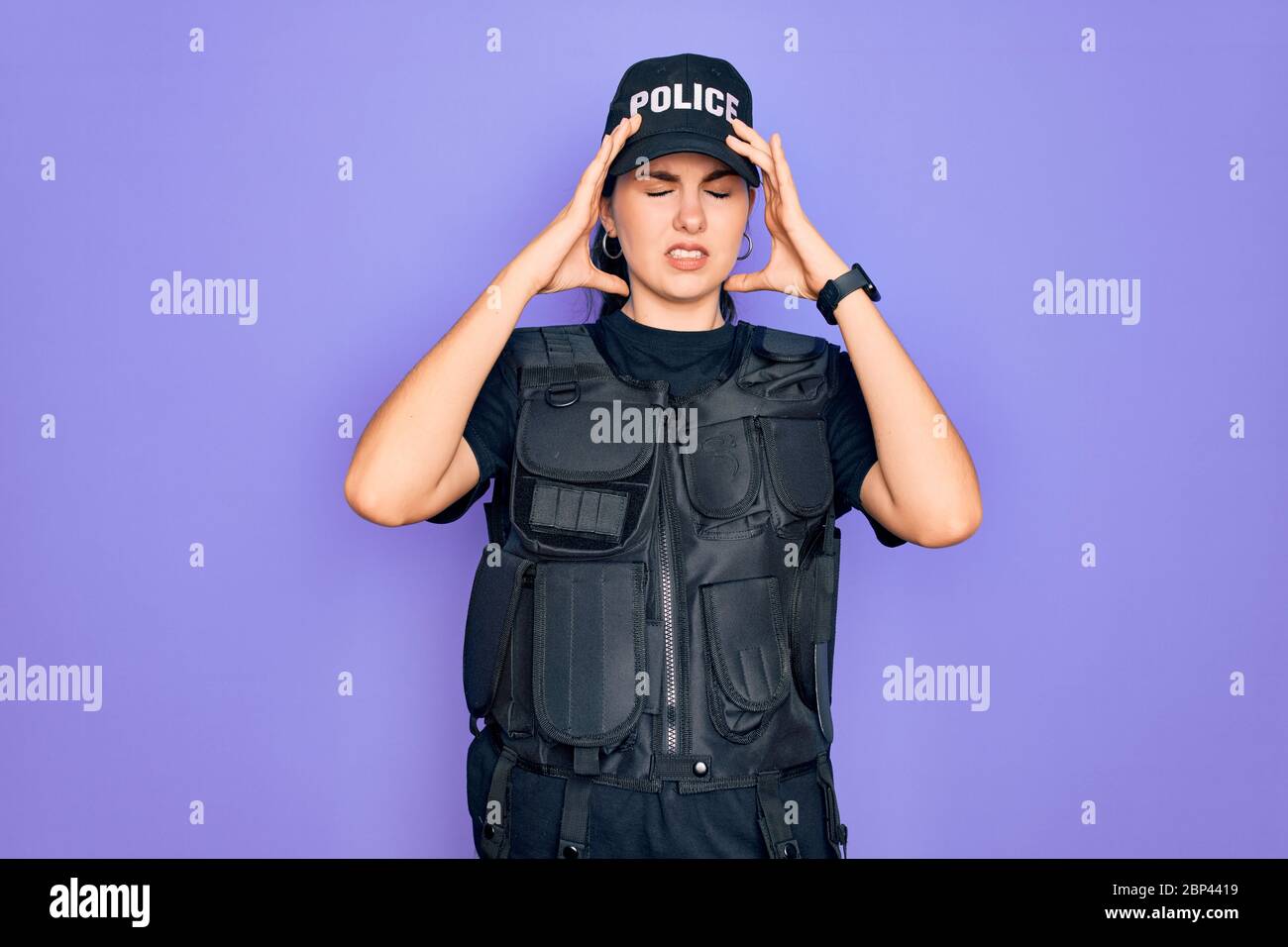 Young police woman wearing security bulletproof vest uniform over ...