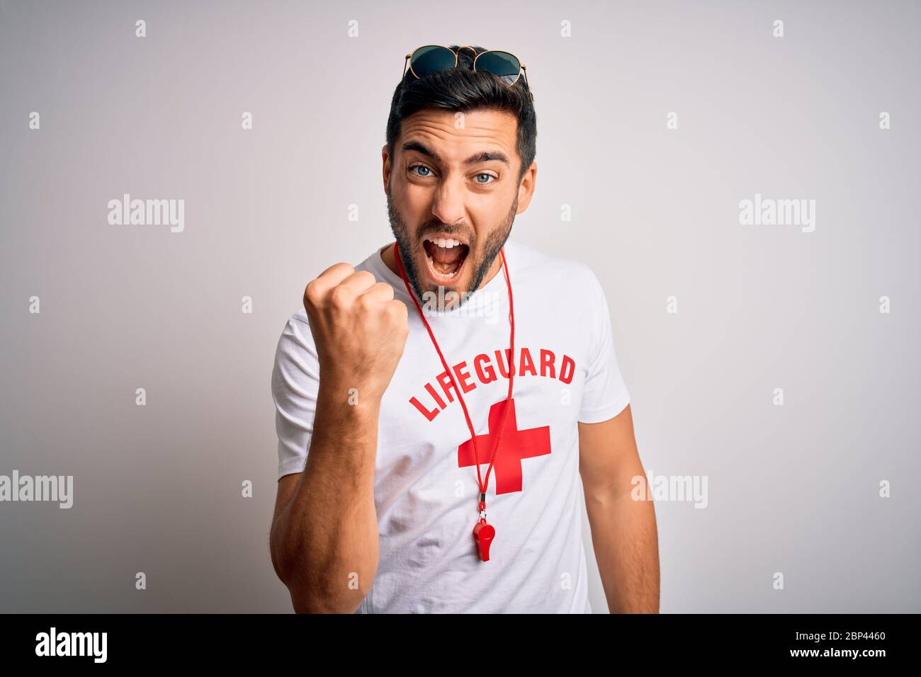 Young handsome lifeguard man with beard wearing t-shirt with red cross ...