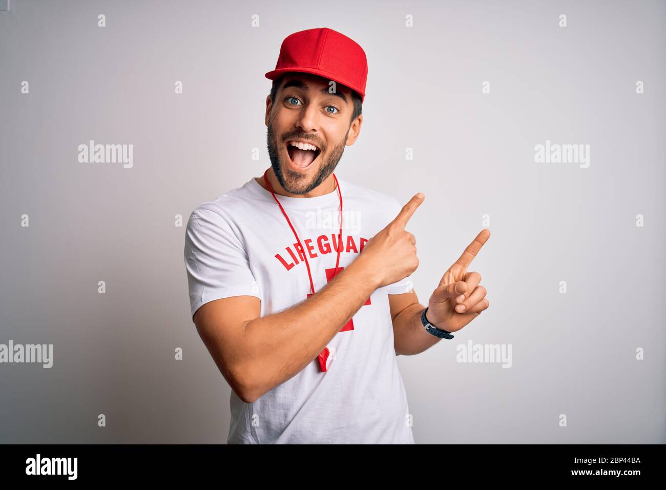 Young handsome lifeguard man with beard wearing t-shirt with red cross ...