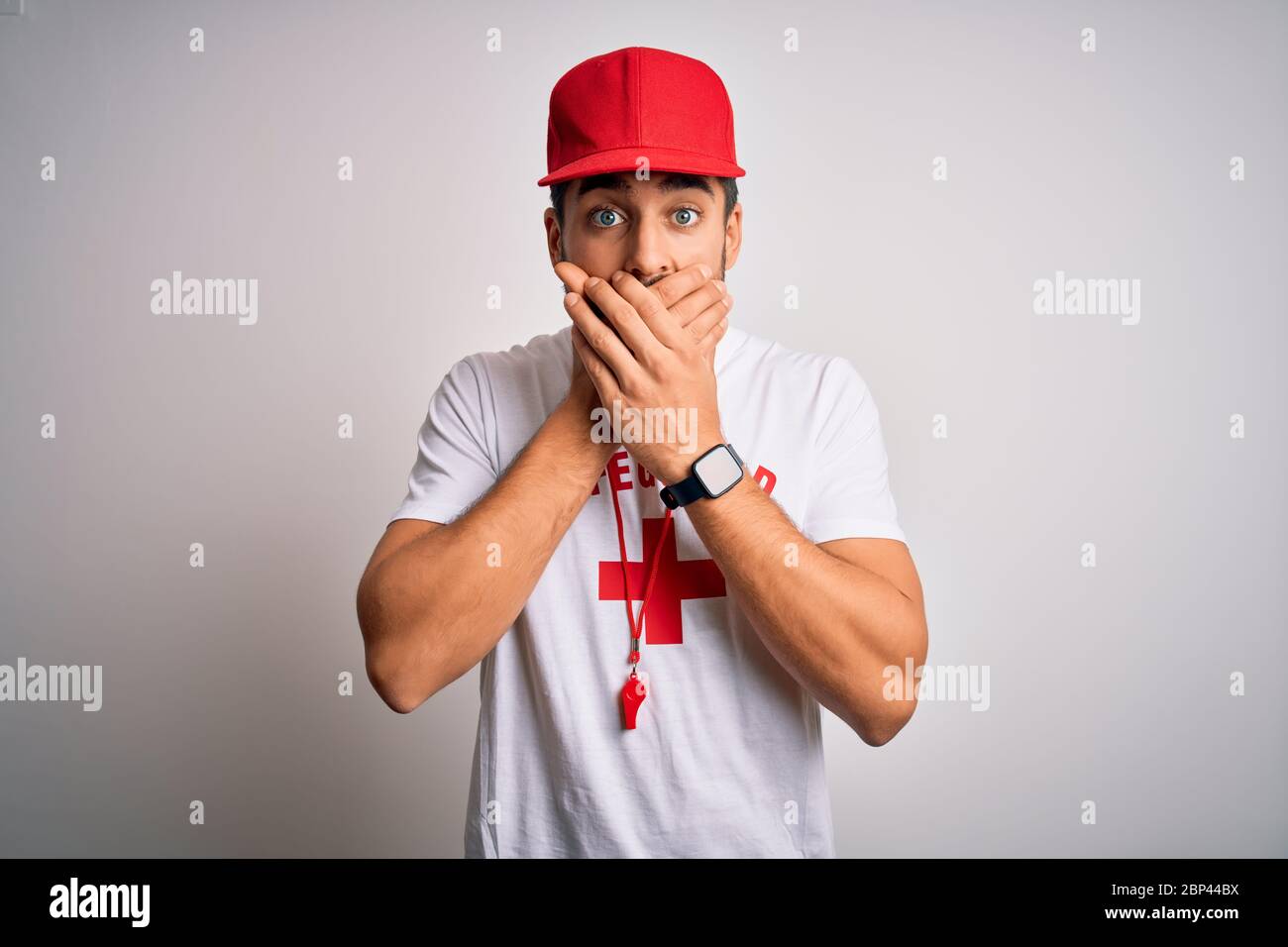 Young handsome lifeguard man with beard wearing t-shirt with red cross ...