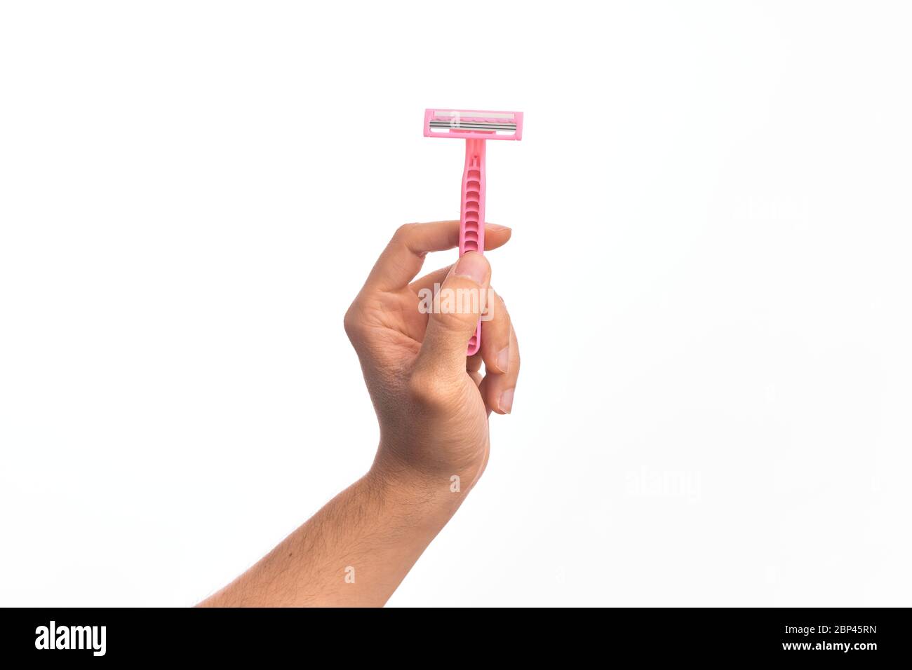 Hand of caucasian young man holding pink disposible razor over isolated ...