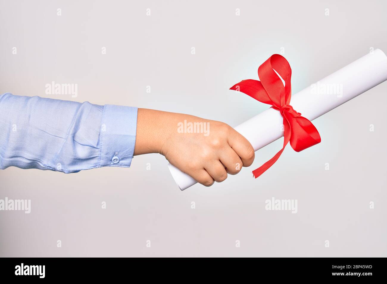 Hand of caucasian young woman holding graduated diploma degree over ...