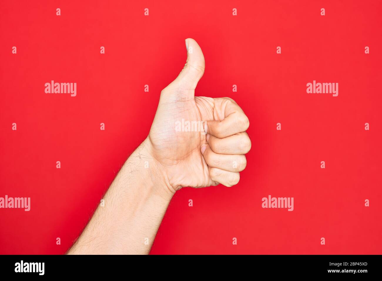 Hand of caucasian young man showing fingers over isolated red ...