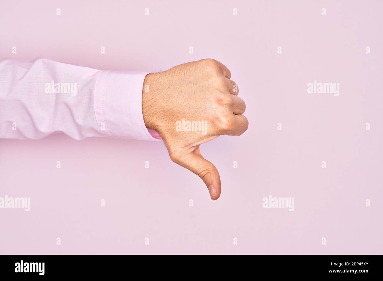 Hand of caucasian young man showing fingers over isolated pink ...
