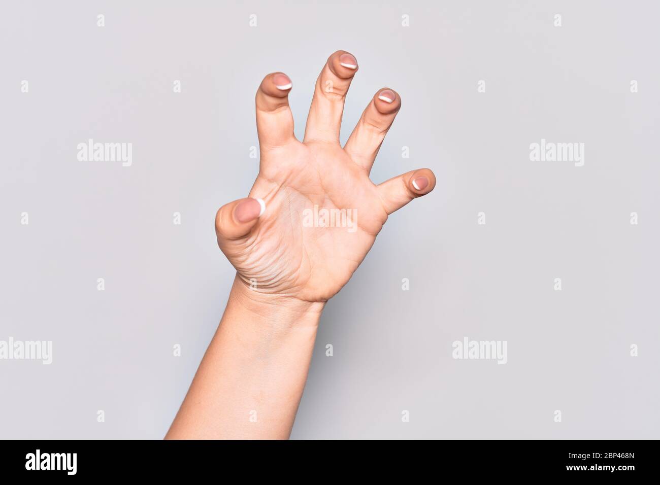 Hand of caucasian young woman grasping aggressive and scary with ...
