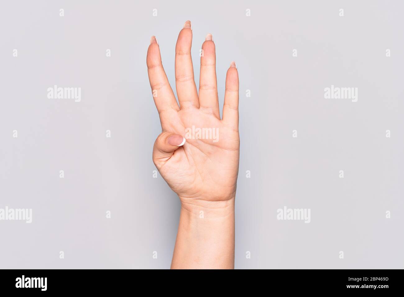 Hand of caucasian young woman counting number 4 showing four fingers ...