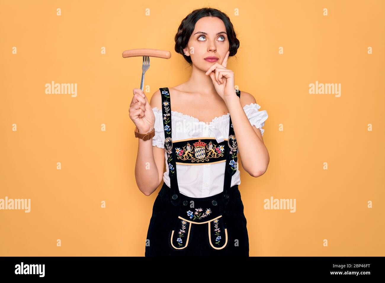 Young german woman with blue eyes wearing octoberfest dress holding ...