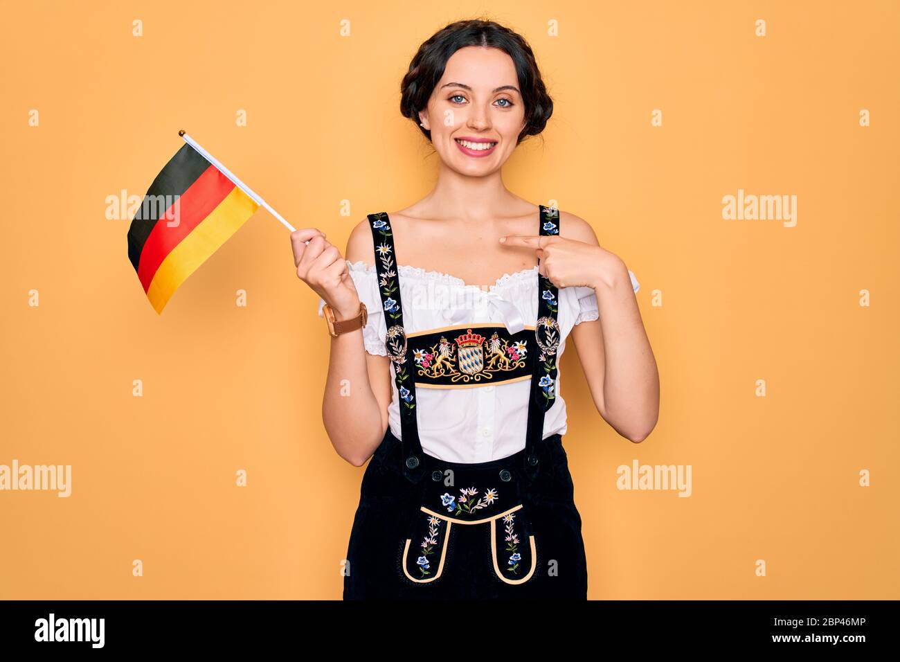 Young patriotic german woman with blue eyes wearing octoberfest dress ...