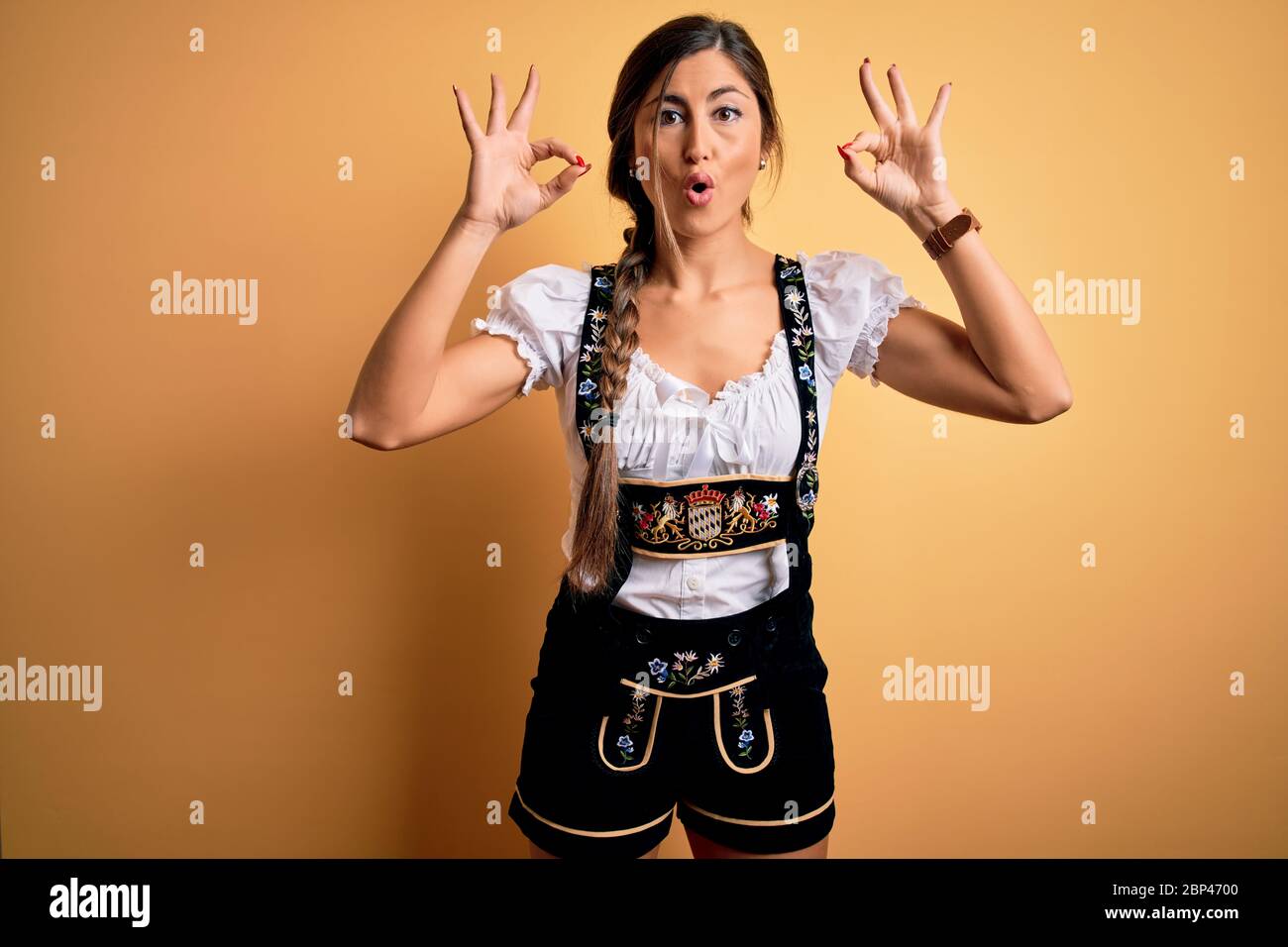 Young beautiful brunette german woman celebrating Octoberfest wearing ...