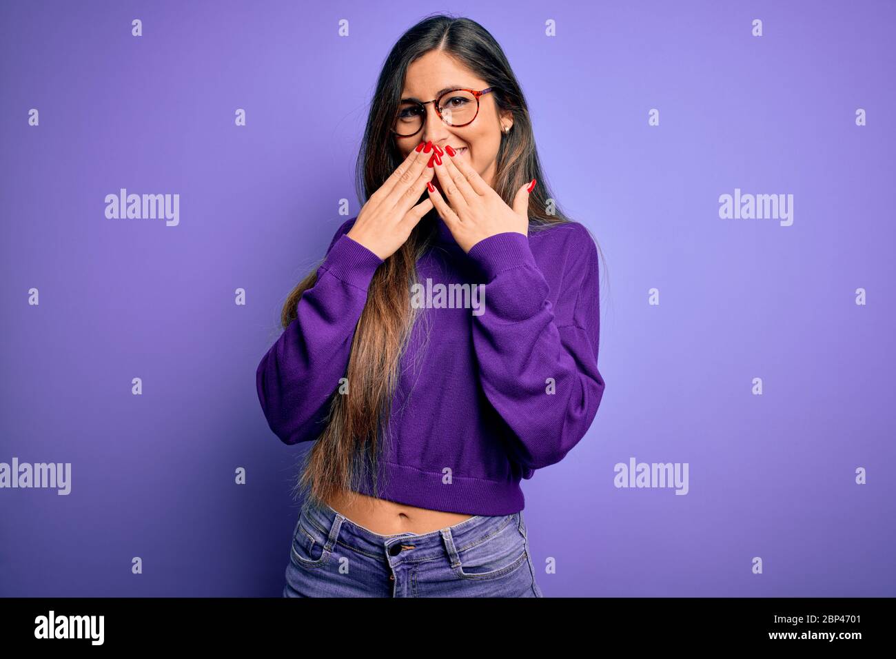 Young beautiful smart woman wearing glasses over purple isolated ...
