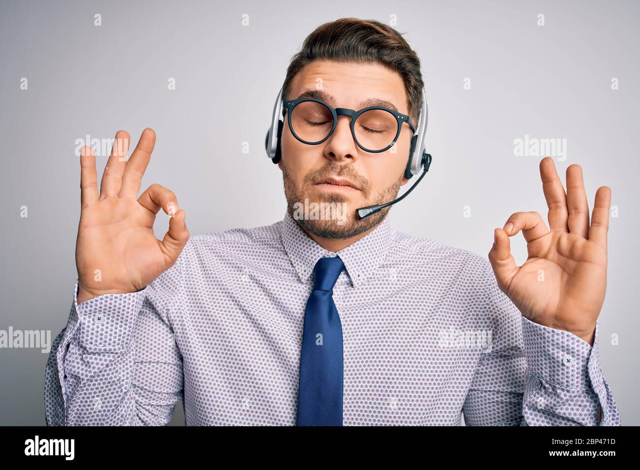 Young call center operator business man with blue eyes wearing glasses ...
