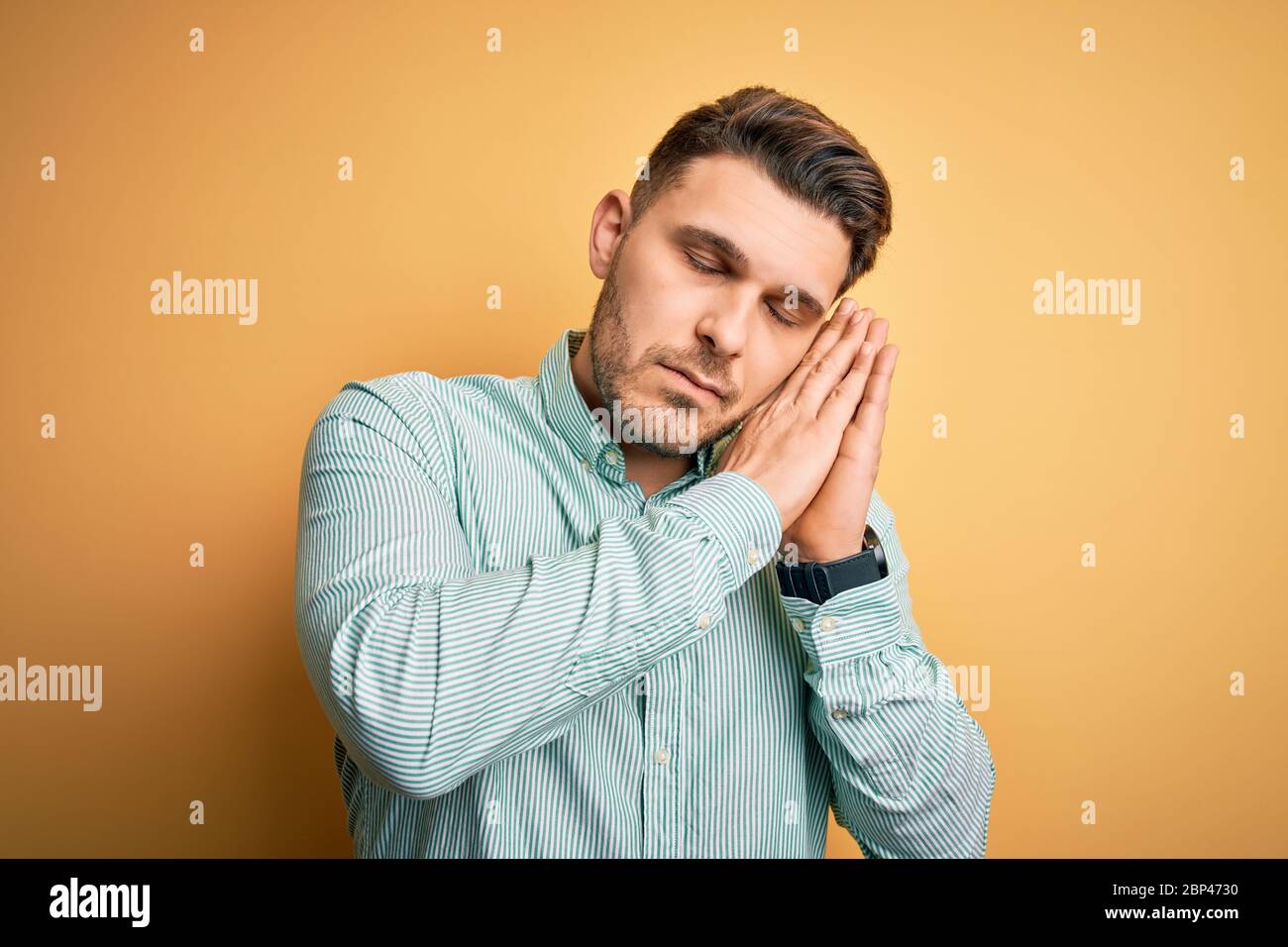 Young business man with blue eyes wearing elegant green shirt over ...