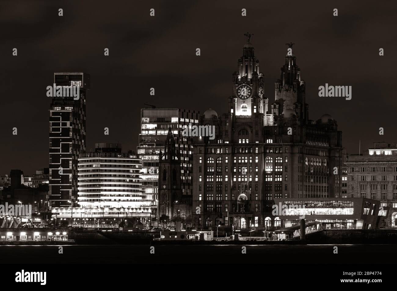 Liverpool Royal Liver Building at night with buildings in England in ...