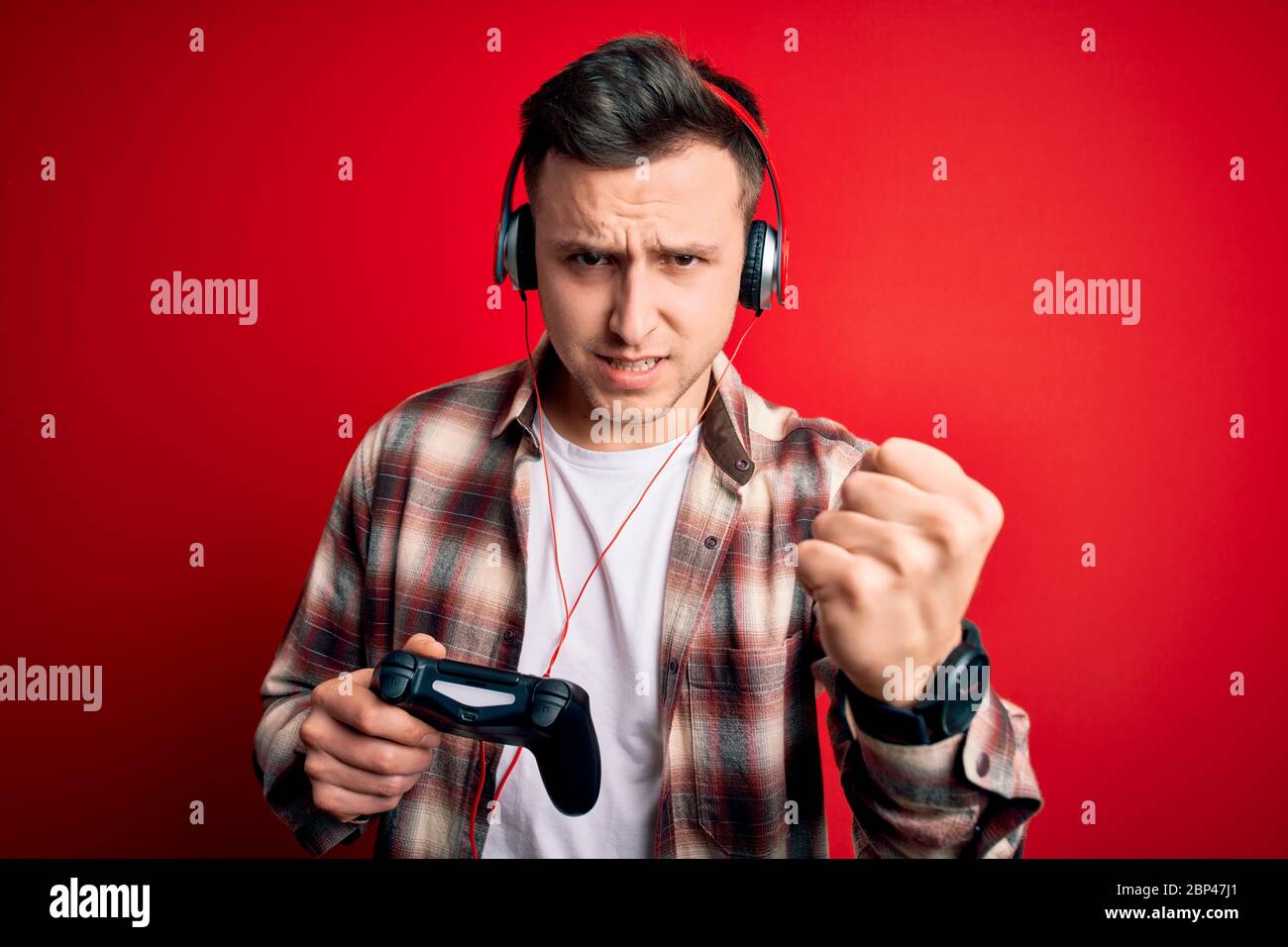 Young handsome caucasian gamer man playing video games using console ...