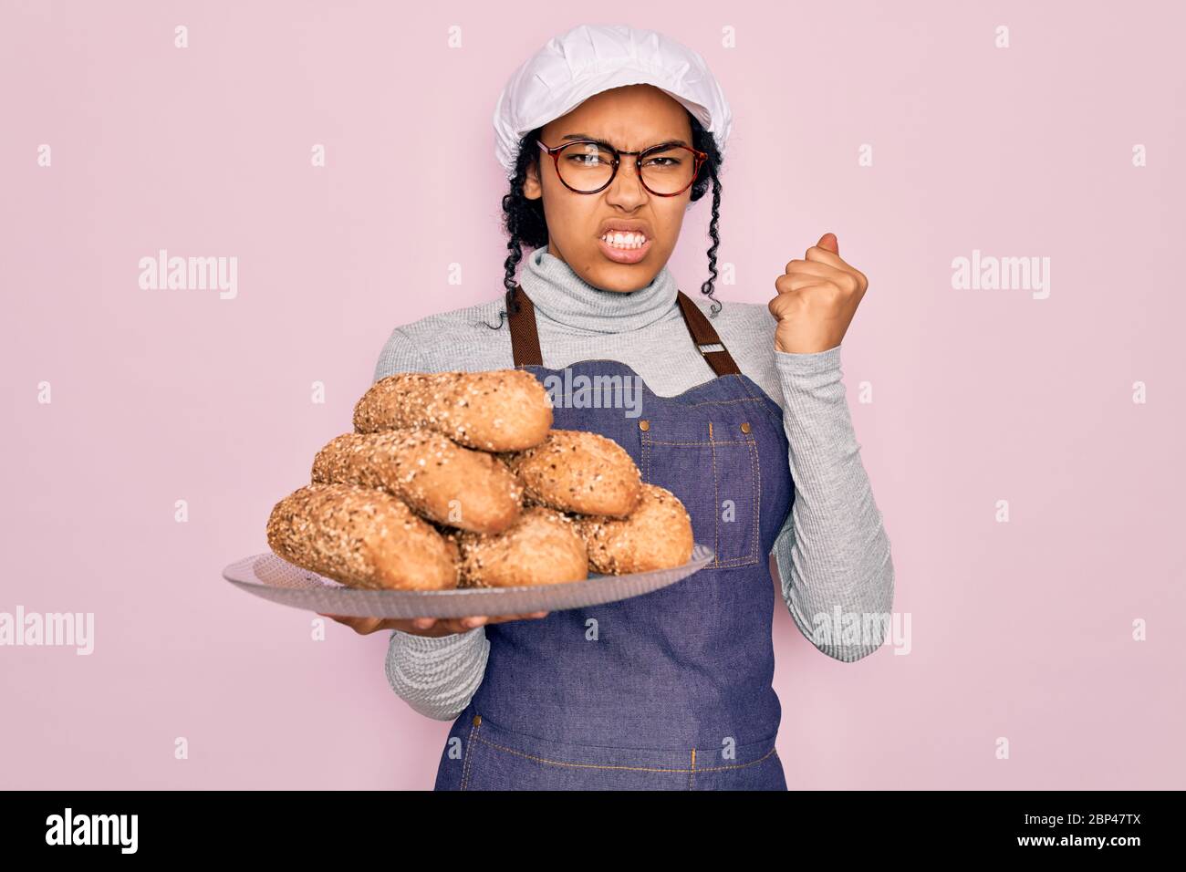 Young african american baker woman wearing apron holding wholemeal ...