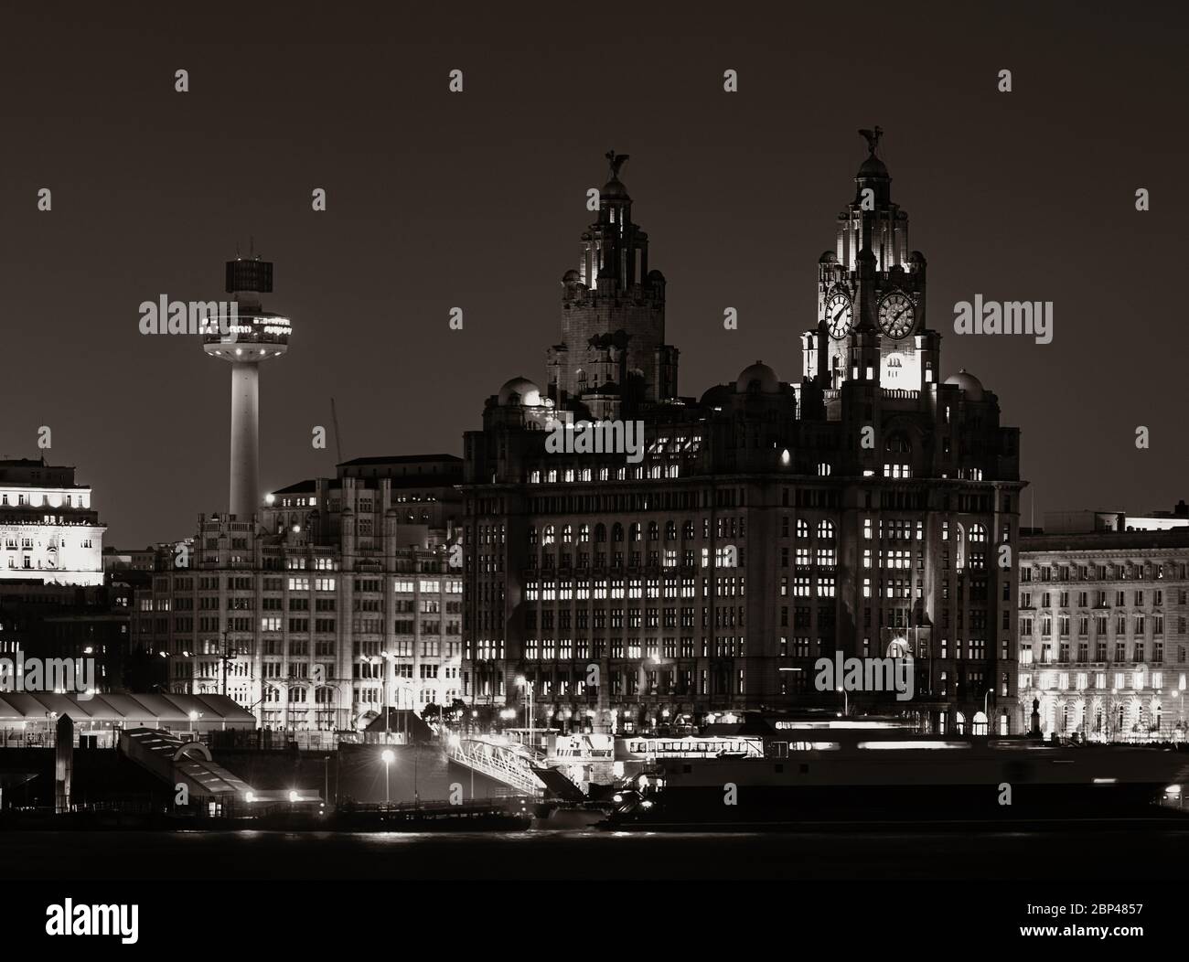 Liverpool Royal Liver Building at night with buildings in England in ...