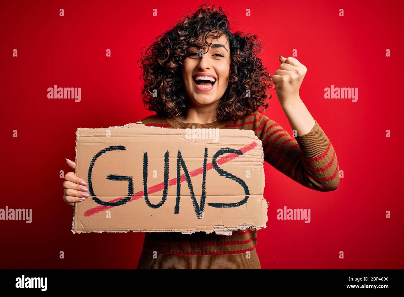Young beautiful arab woman asking for peace holding banner with ...
