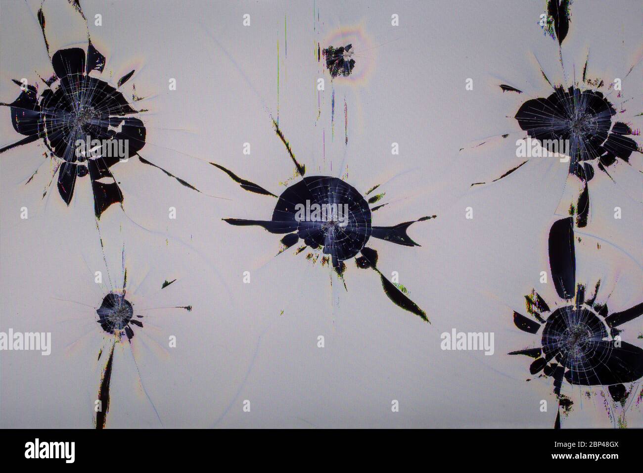 close-up view of physically damaged lcd screen surface with multiple ...