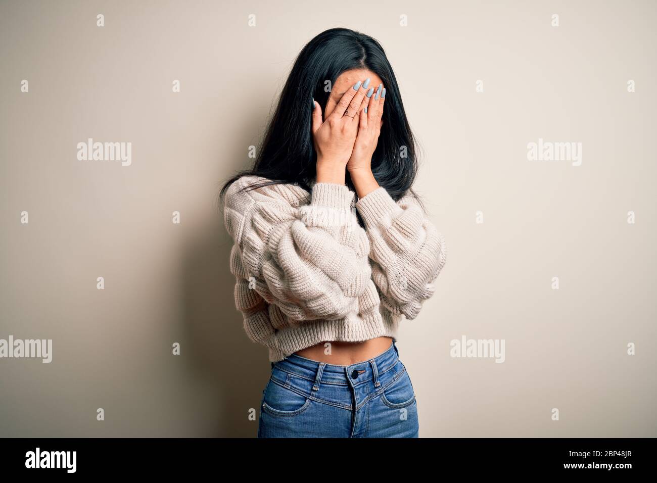 Young beautiful chinese woman wearing casual sweater over isolated ...