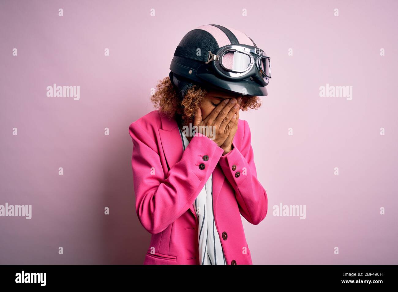 African american motorcyclist woman with curly hair wearing moto helmet ...