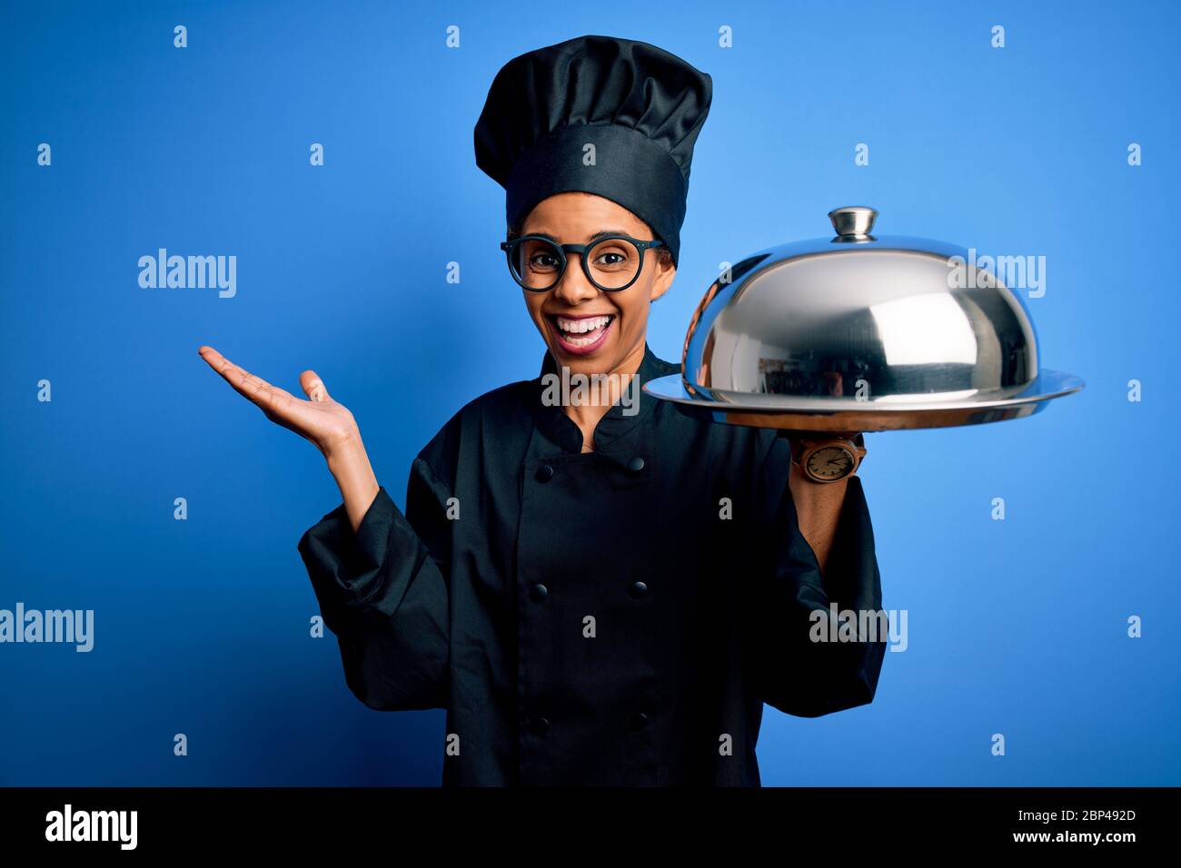Young african american cooker woman wearing uniform holding waiter tray ...