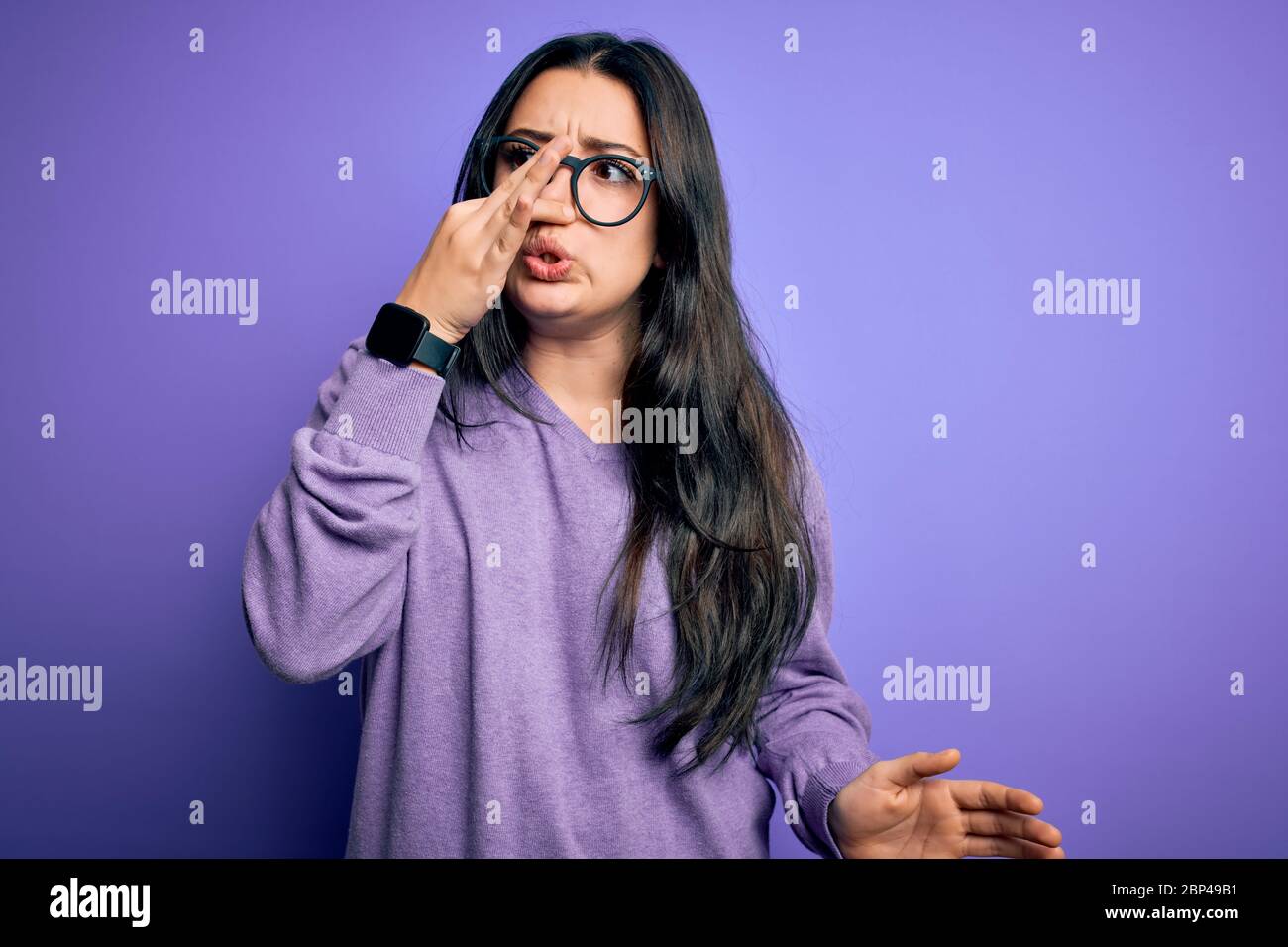 Young Brunette Woman Wearing Glasses Over Purple Isolated Background